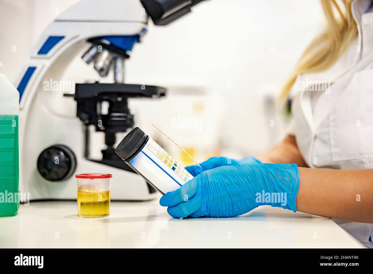 Microbiology and biochemistry. A nurse is sitting in a lab and ...