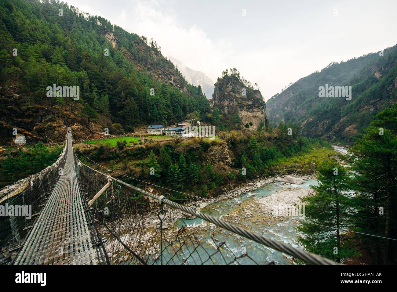 Suspension bridge with buddhist prayer flags on the Annapurna circuit ...