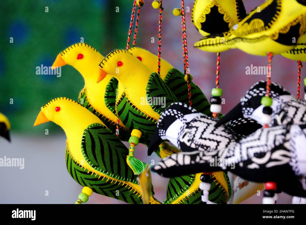 Colourful hanging birds that decorated with colorful handmade clothes ...