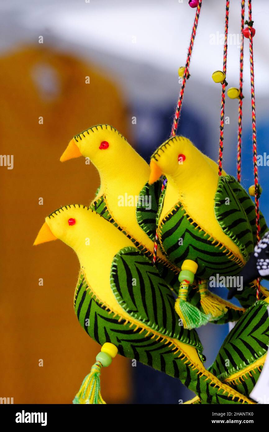 Colourful hanging birds that decorated with colorful handmade clothes ...