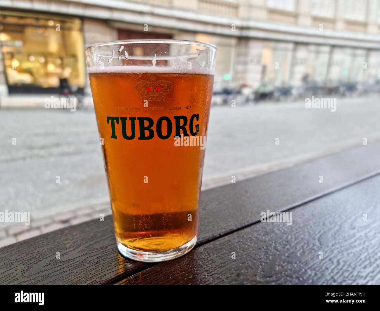 COPENHAGEN, DENMARK - Nov 12, 2021: The Tuborg glass of beer on a table ...