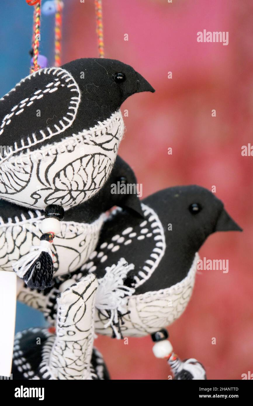 Colourful hanging birds that decorated with colorful handmade clothes ...