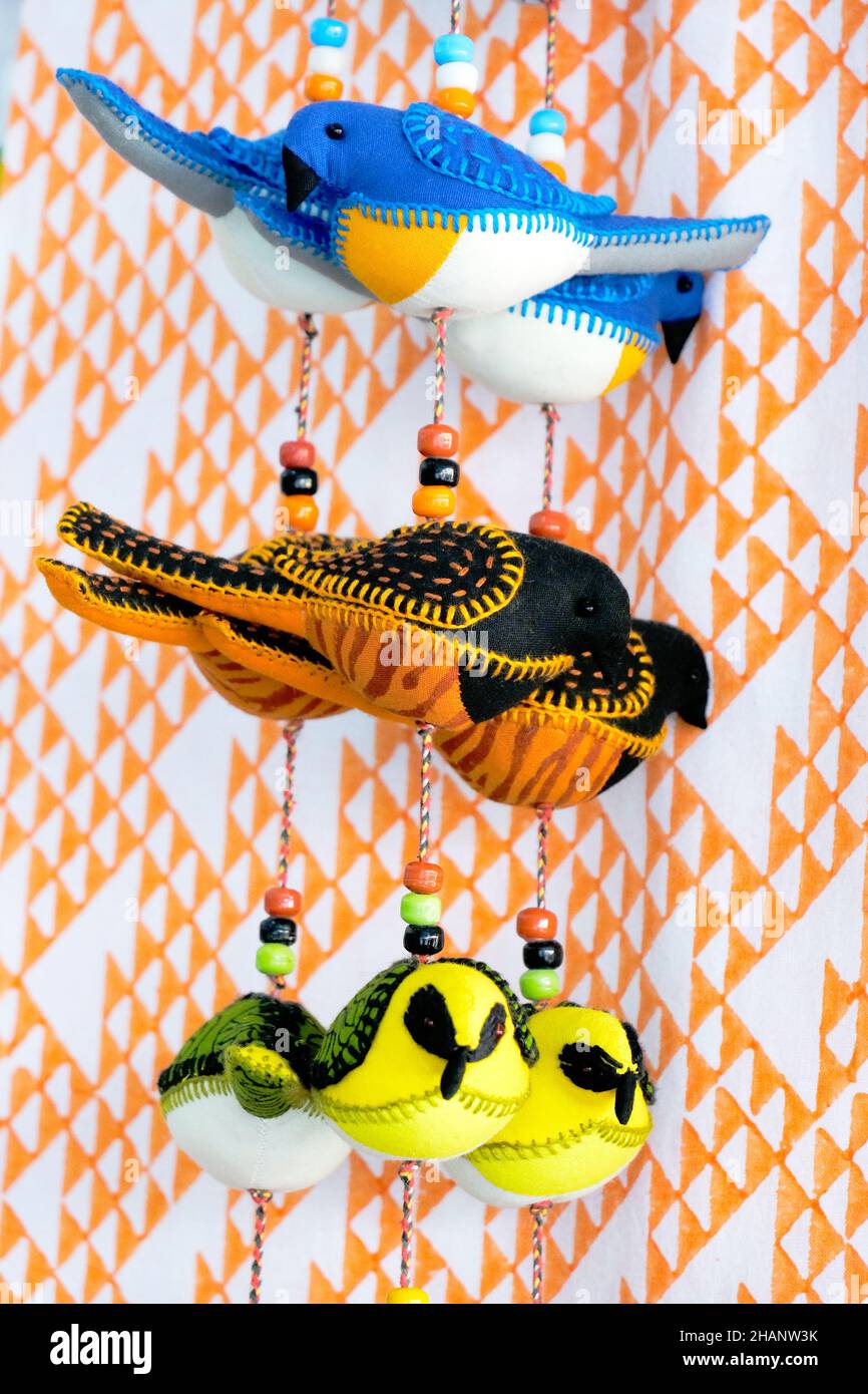 Colourful hanging birds that decorated with colorful handmade clothes ...