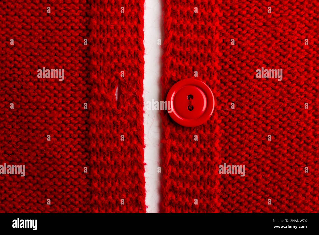 Hand knitted red color wool sweater,on the white surface.Detail taken ...