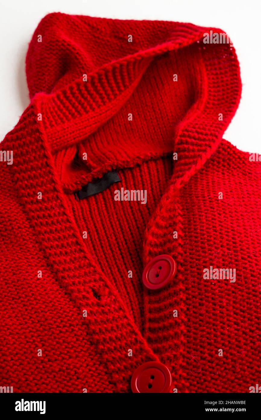 Red color,hooded,hand knitted wool sweater for winter folded on white ...
