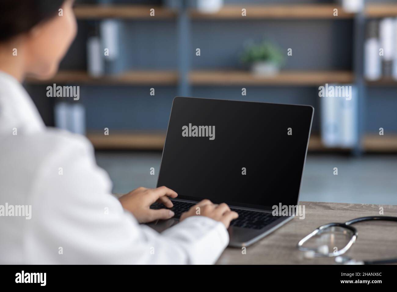 Doctor typing computer hi-res stock photography and images - Alamy