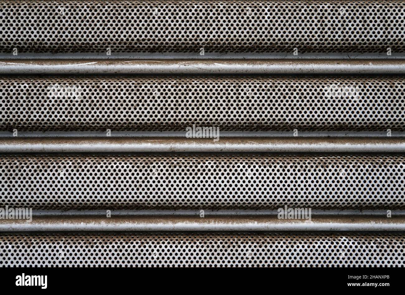 Perforated metallic surface texture background Stock Photo - Alamy