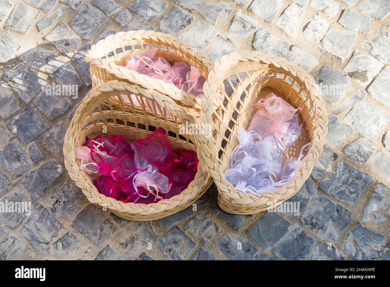 Organza sachets with heel protectors inside three wicker baskets during ...