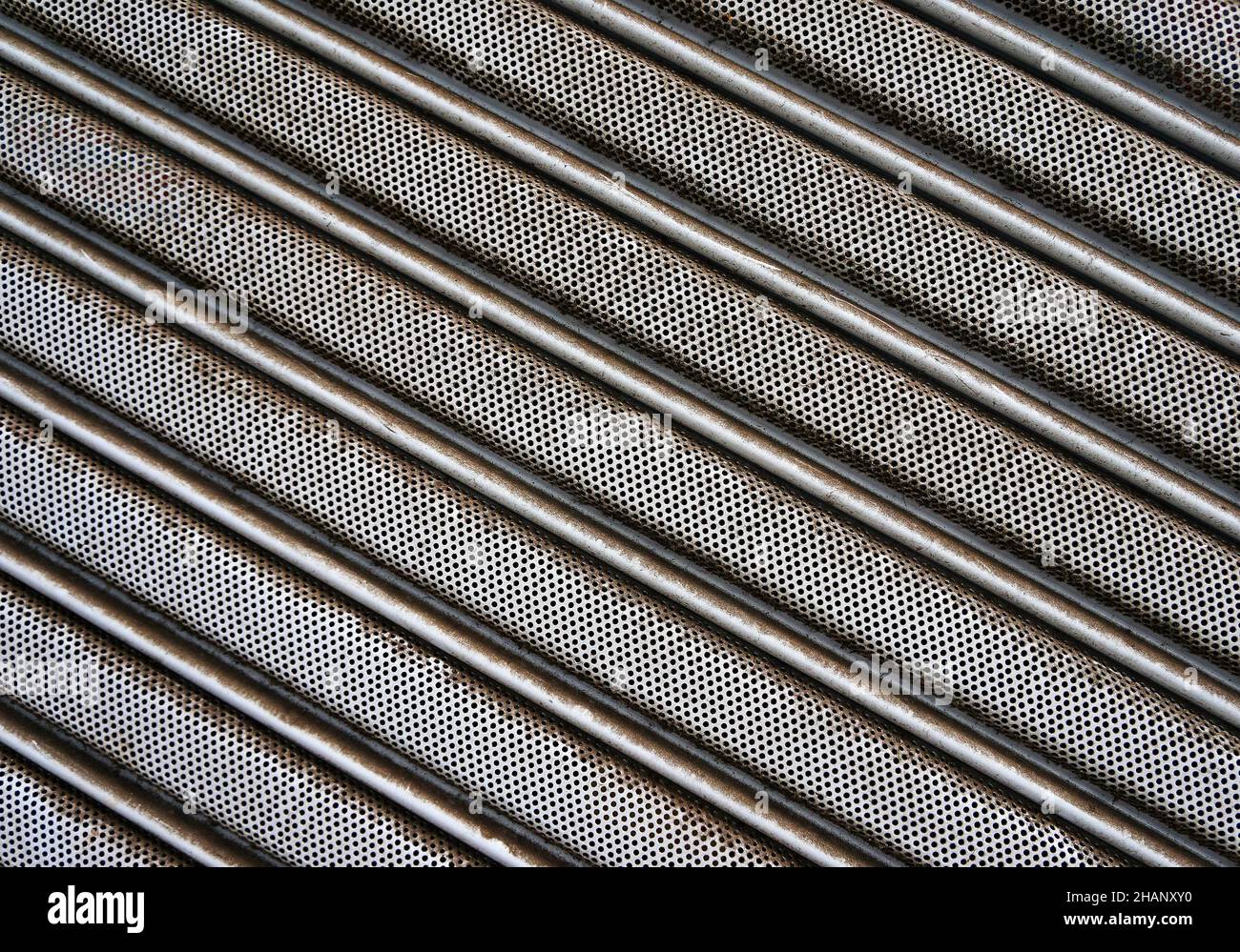 Perforated metallic surface texture background Stock Photo - Alamy