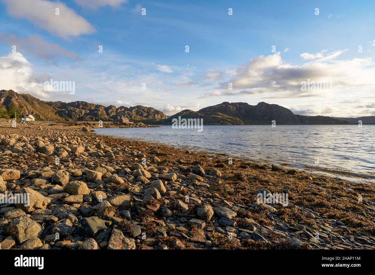 The rocky, seaweed-covered beach at Lower Diabaig, Wester Ross, early ...