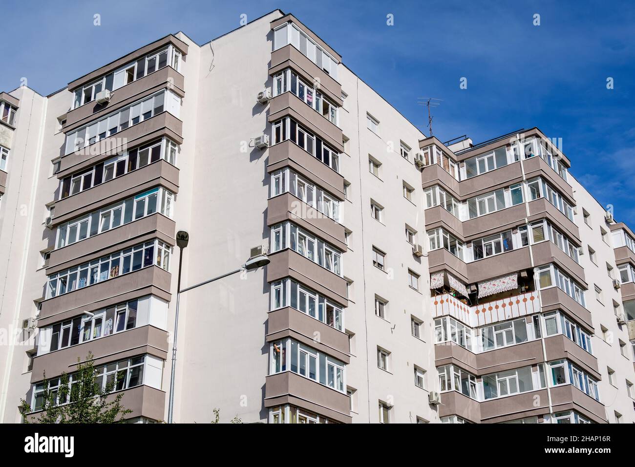 Renovated typical old block of flats towards clear blue sky in ...