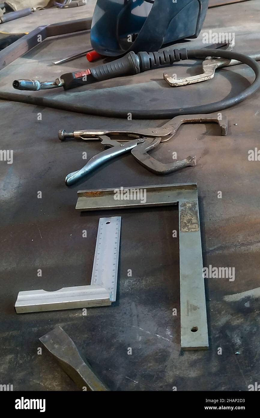 the workplace of a locksmith welder with different tools at the factory ...