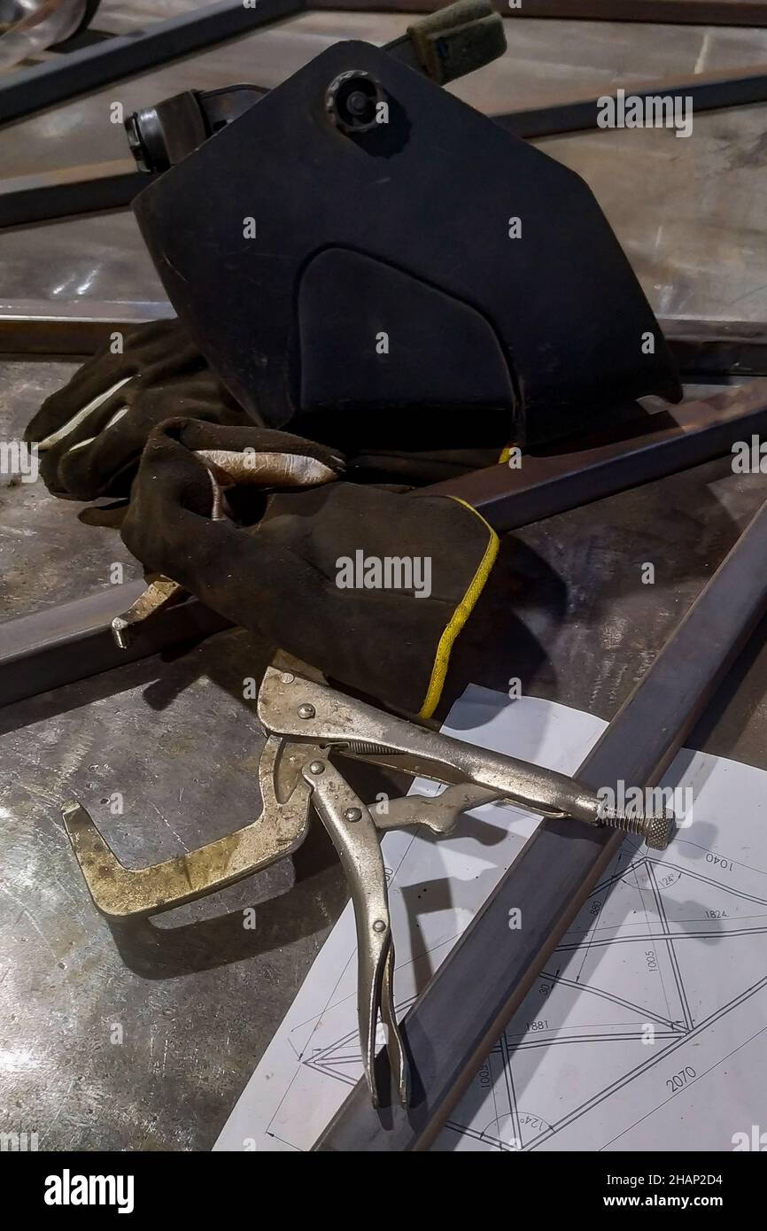 the workplace of a locksmith welder with different tools at the factory ...