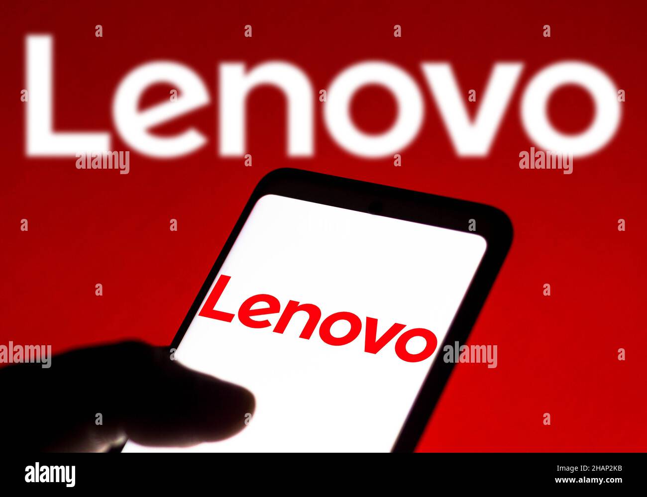 In this photo illustration, a Lenovo logo seen displayed on a ...