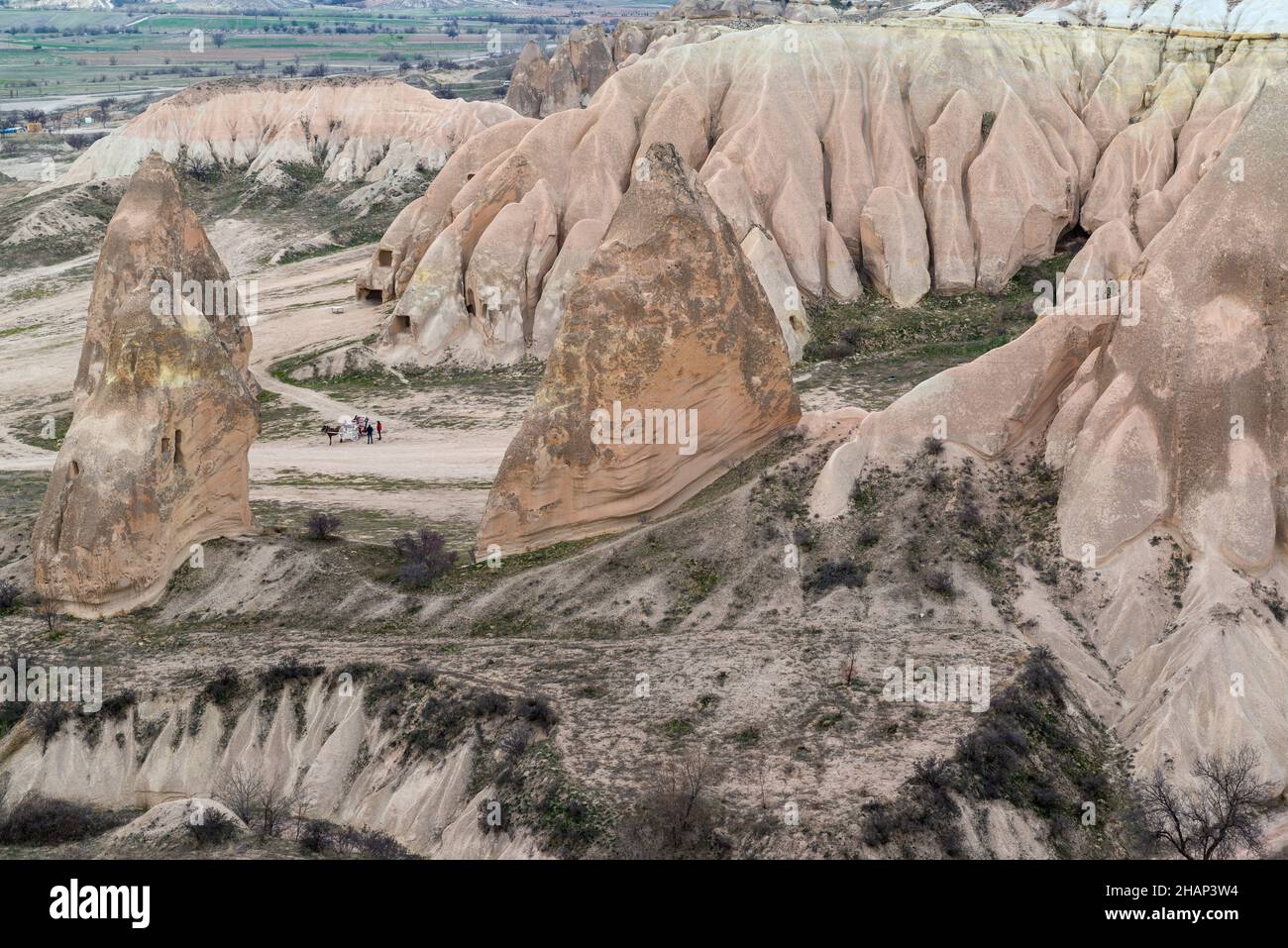 Coach on a sand road between the famous fairy chimneys of Cappadocia ...