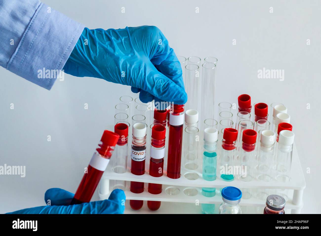 Gloved hand holding test tubes hi-res stock photography and images - Alamy