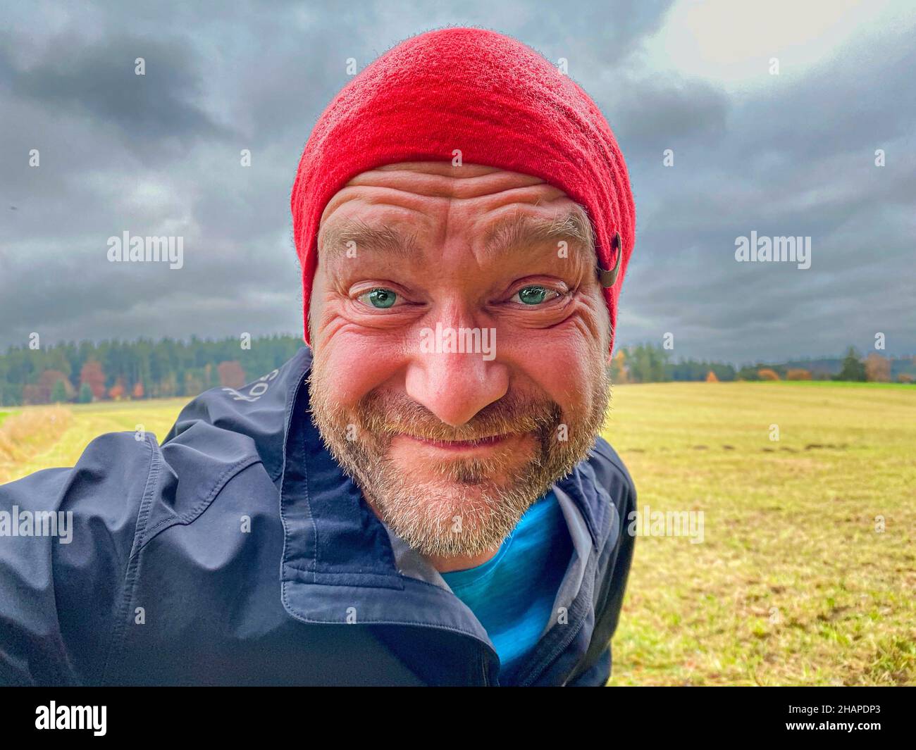 Running Happy Man with Red Cap in Forest Stock Photo - Alamy