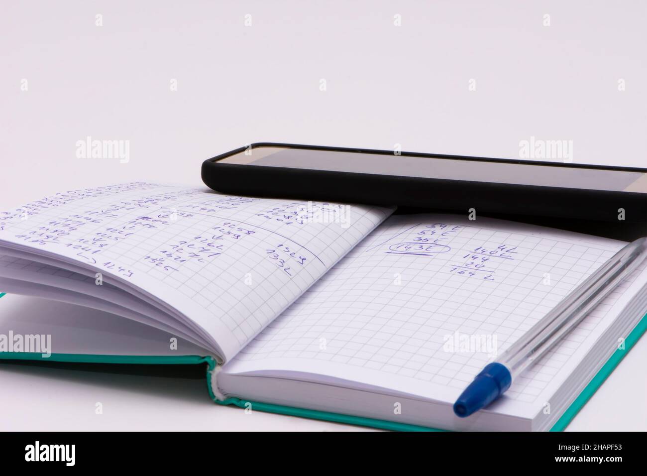 Notebook pen and phone isolated on white background Stock Photo - Alamy