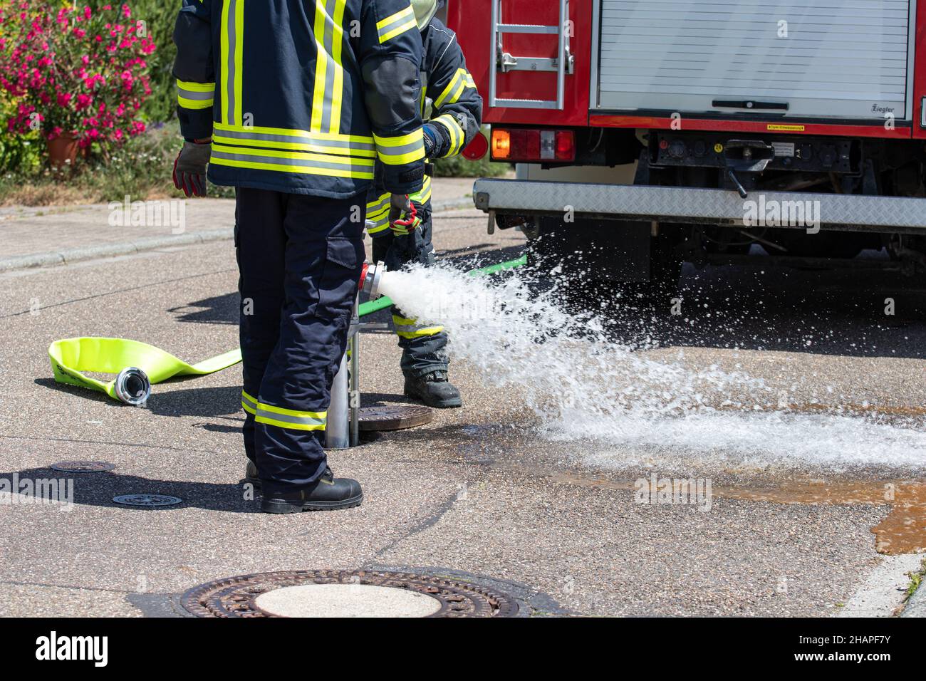 Closeup of German firefighters hard at work during daylight Stock Photo ...