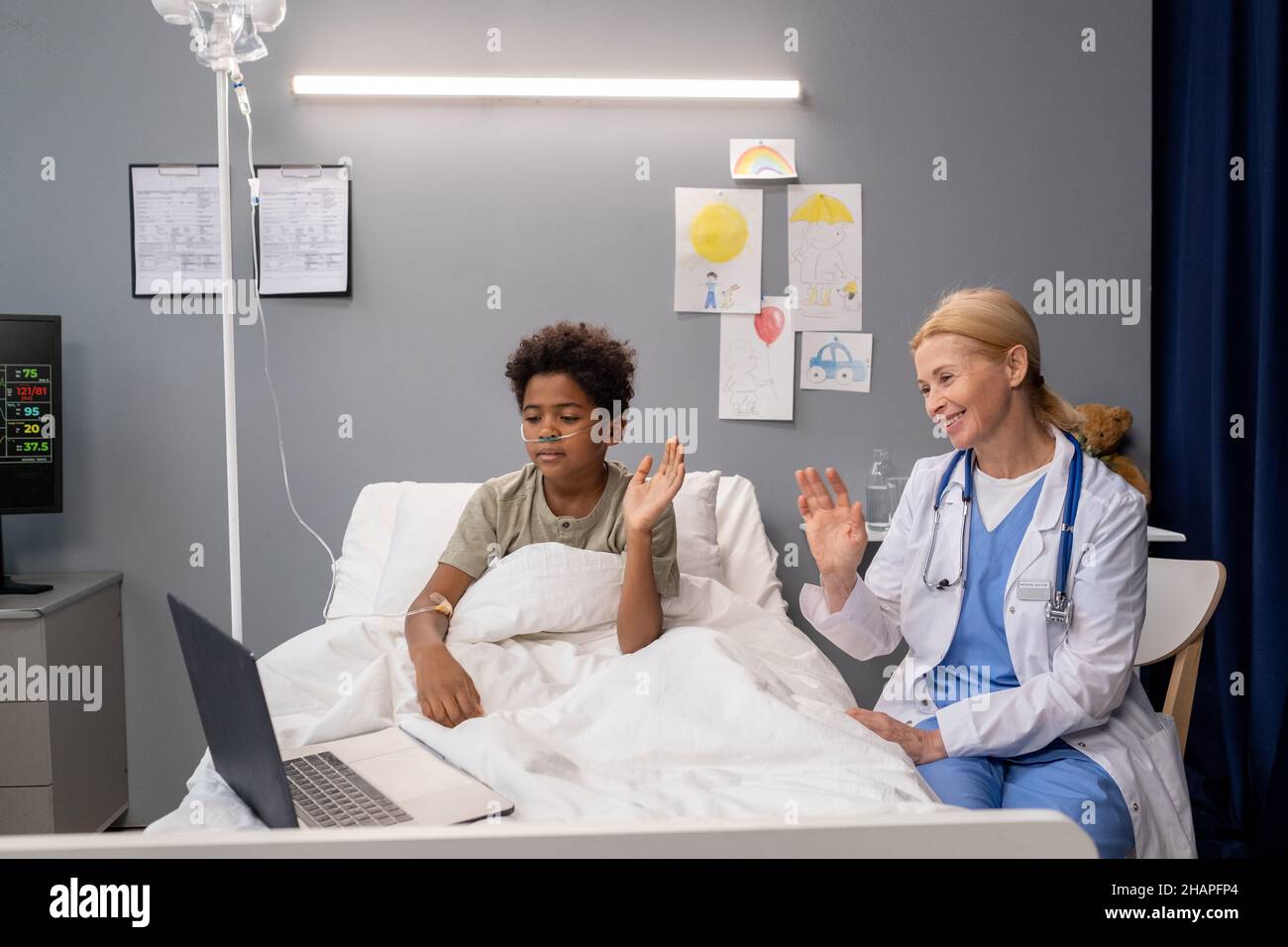 Little boy together with the doctor using laptop for online ...