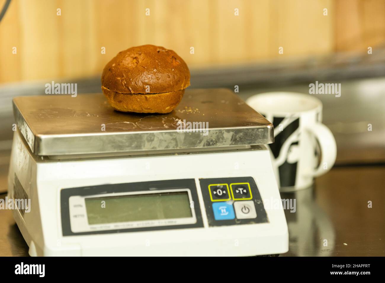 Hamburger in weight scale on white background.Unhealthy food and diet ...