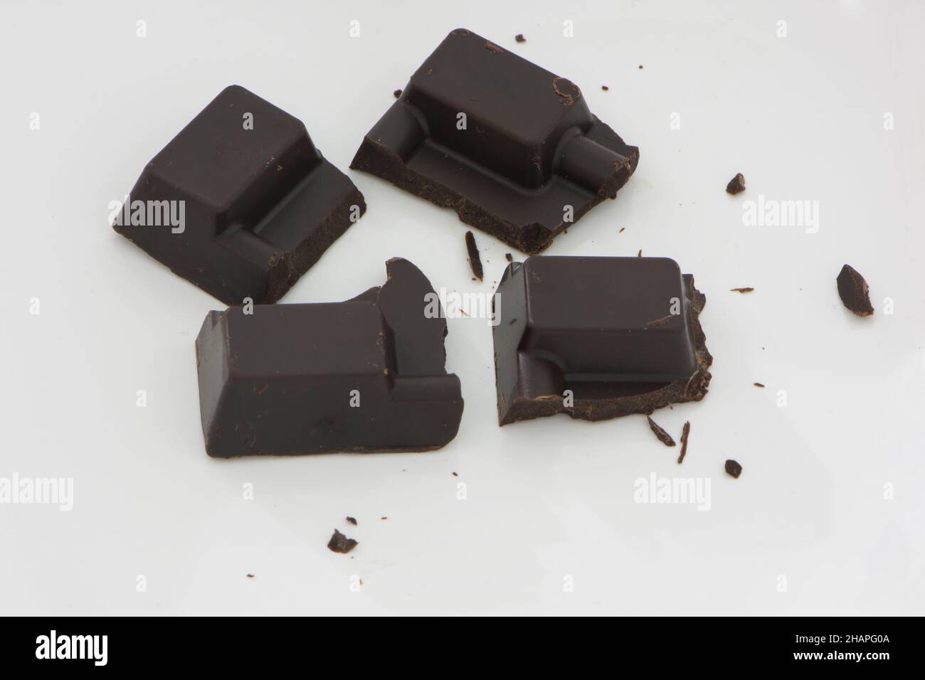 Four cubes of dark healthy chocolate on the white background Stock ...