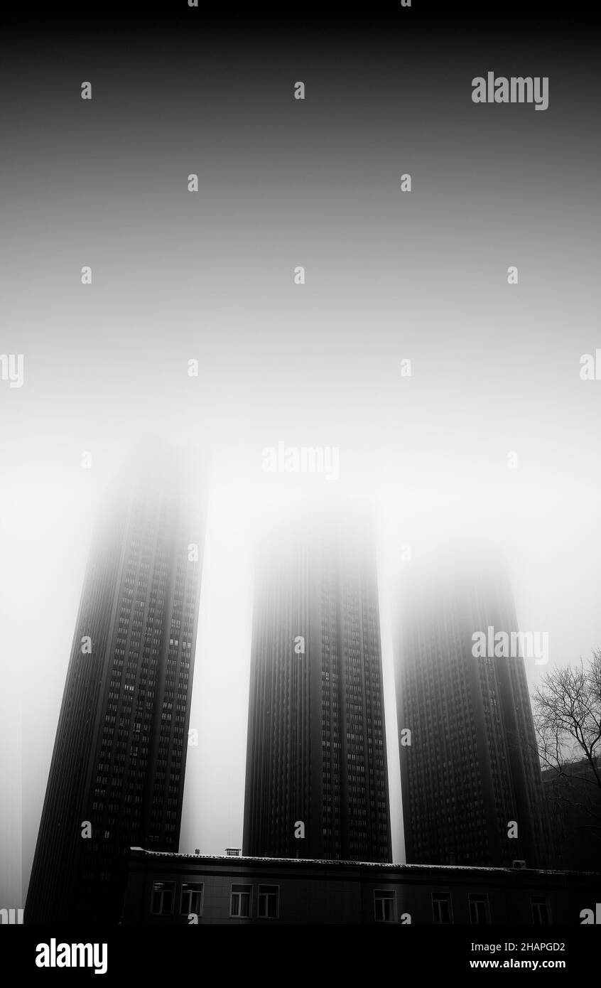 Multiple skyscrapers in fog scary architecture Stock Photo - Alamy