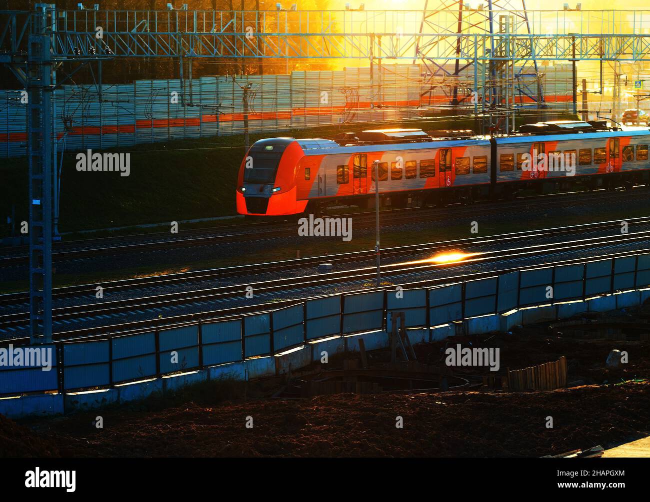 Train during dramatic sunset background Stock Photo - Alamy