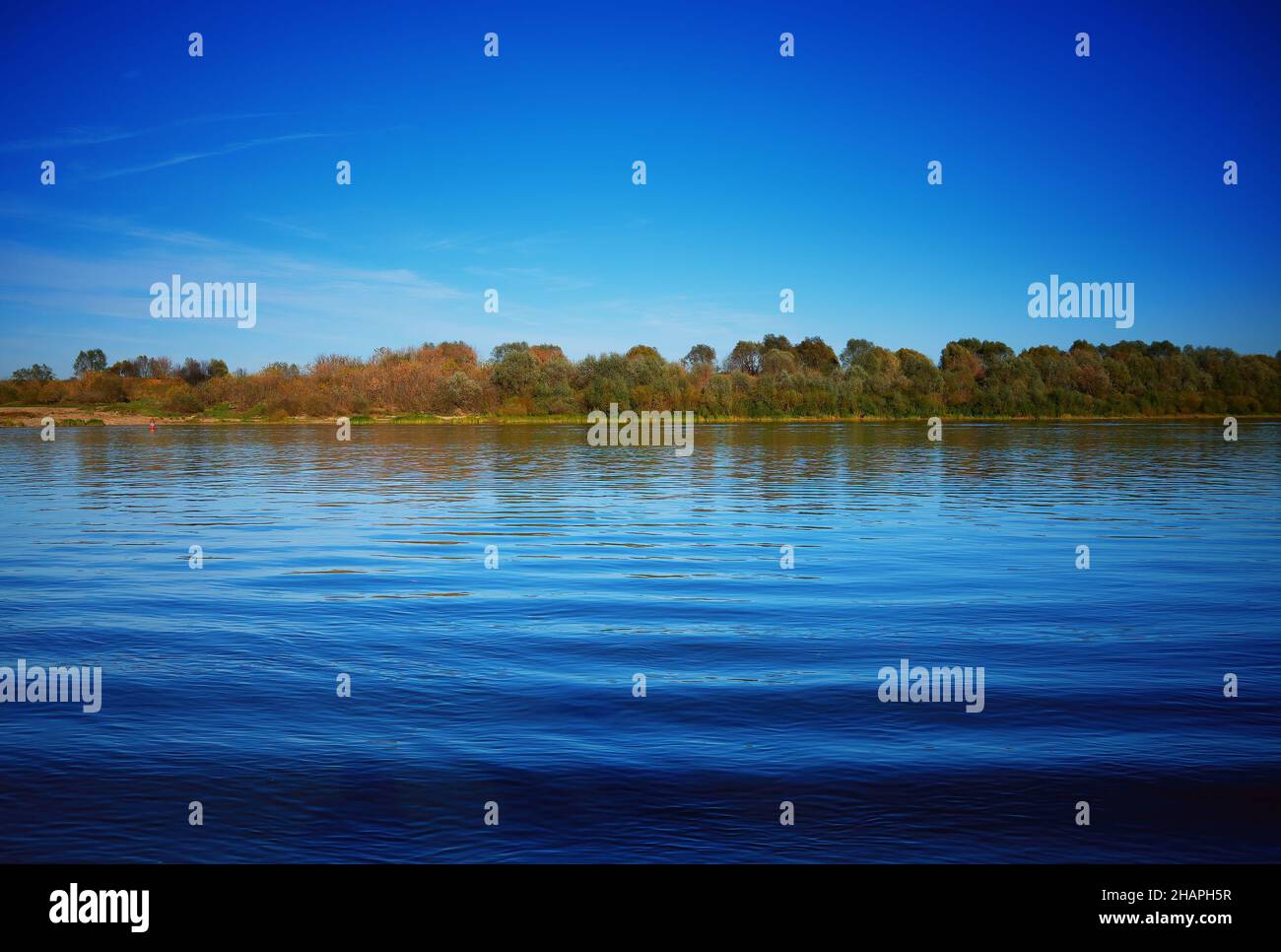Smooth autumn river landscape background Stock Photo - Alamy