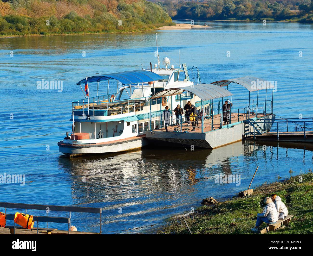 Boarding people at small quay travel background Stock Photo - Alamy