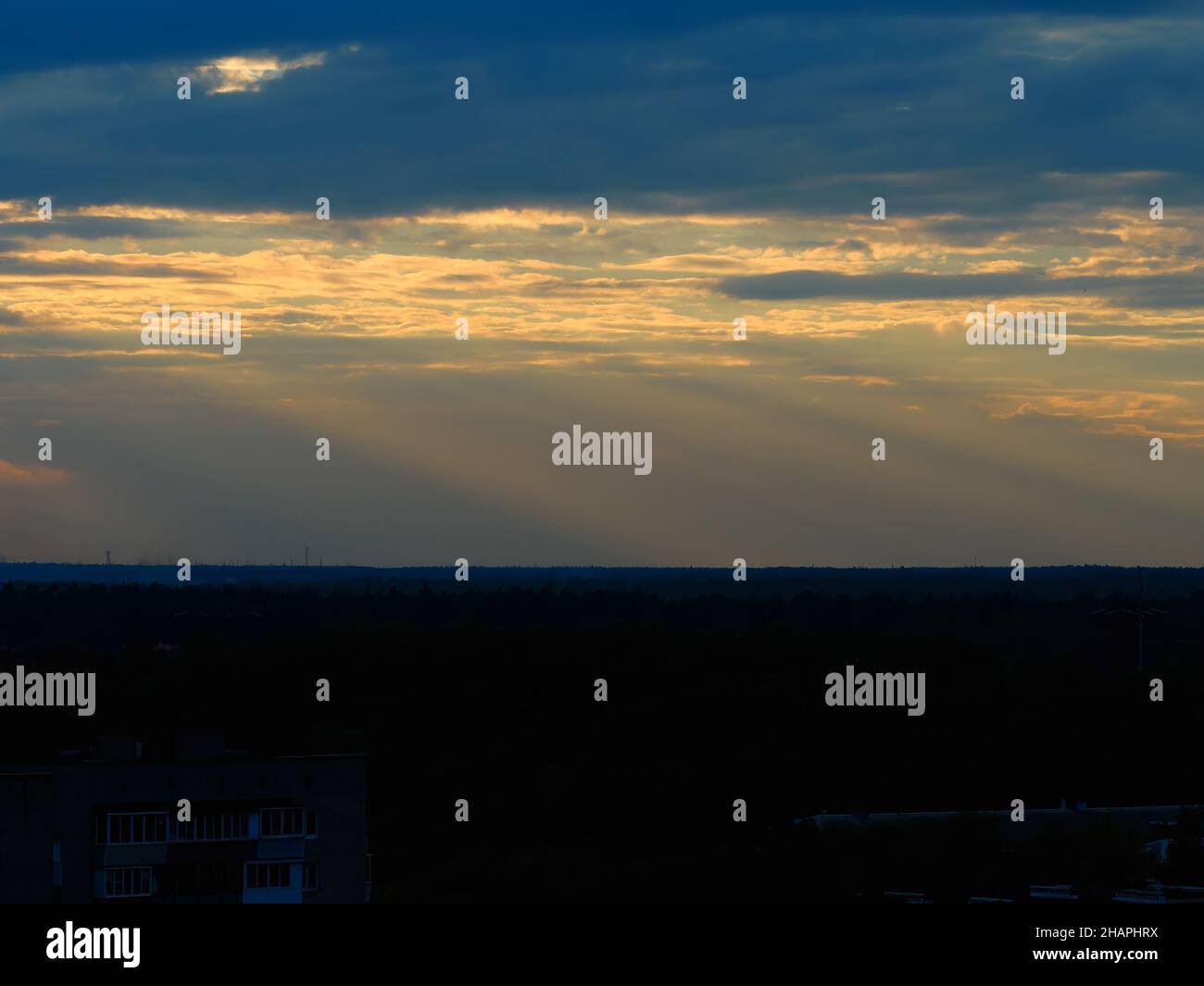 Sunset light rays over the city outskirts backdrop Stock Photo - Alamy
