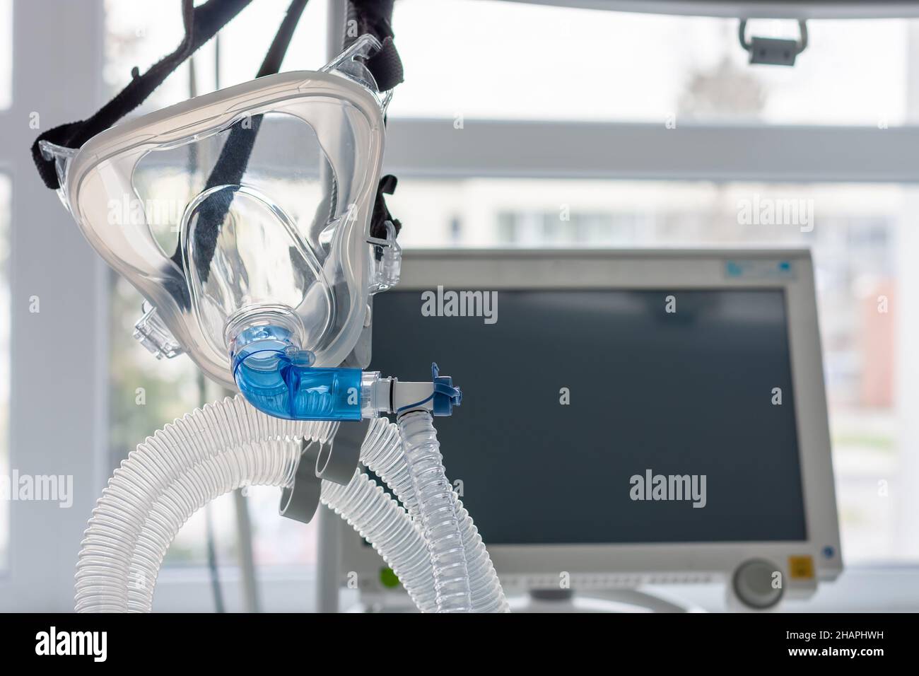 Non-invasive ventilation face mask, on background medical ventilator in ...