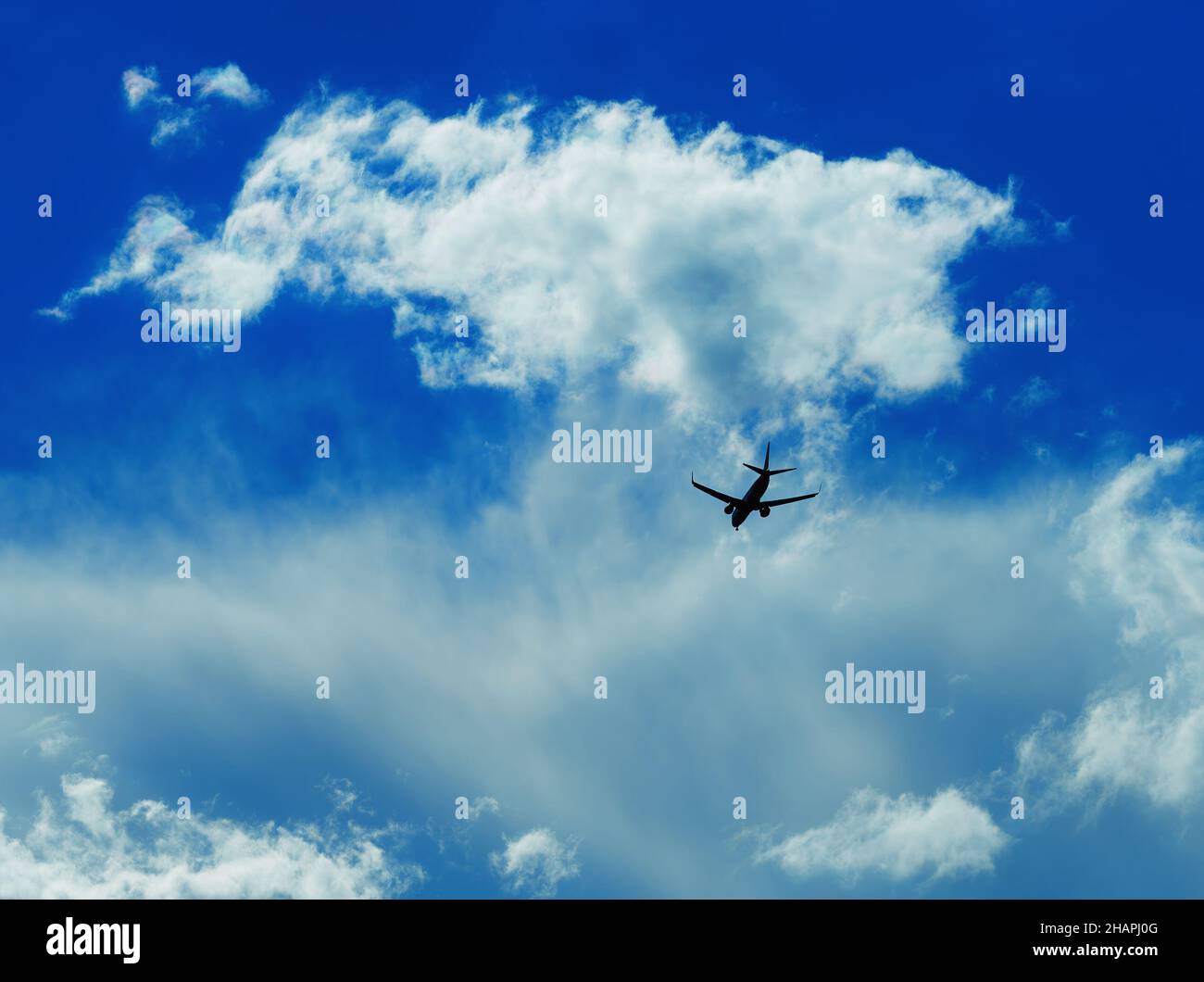 Flying jet in blue skies travel background Stock Photo - Alamy