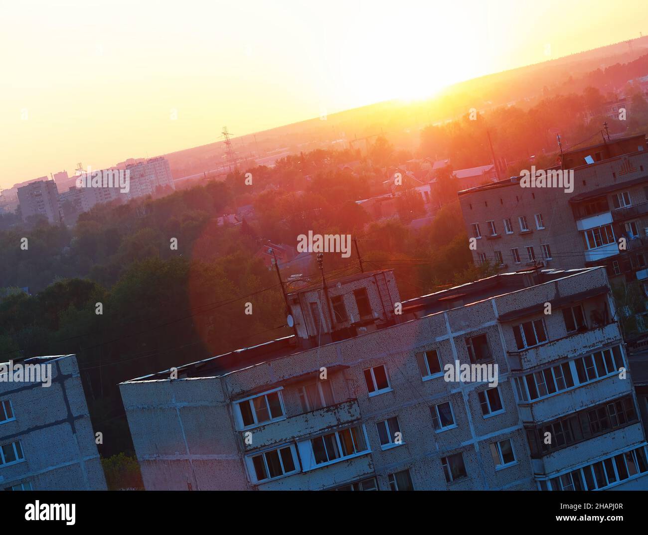 Tilted sunset at small town background Stock Photo - Alamy