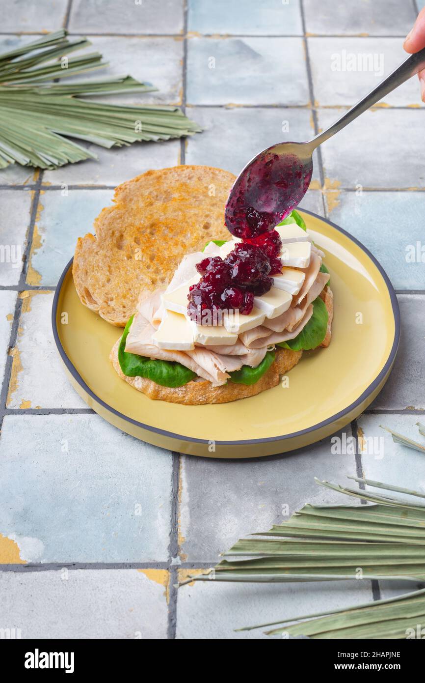 toast with spinach, French cheese Bri ham and jam on tile background ...
