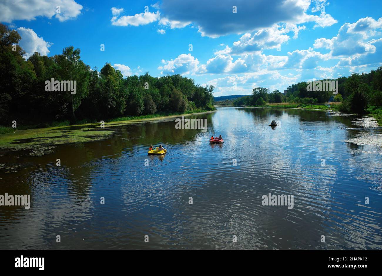 Boats on summer river background Stock Photo - Alamy