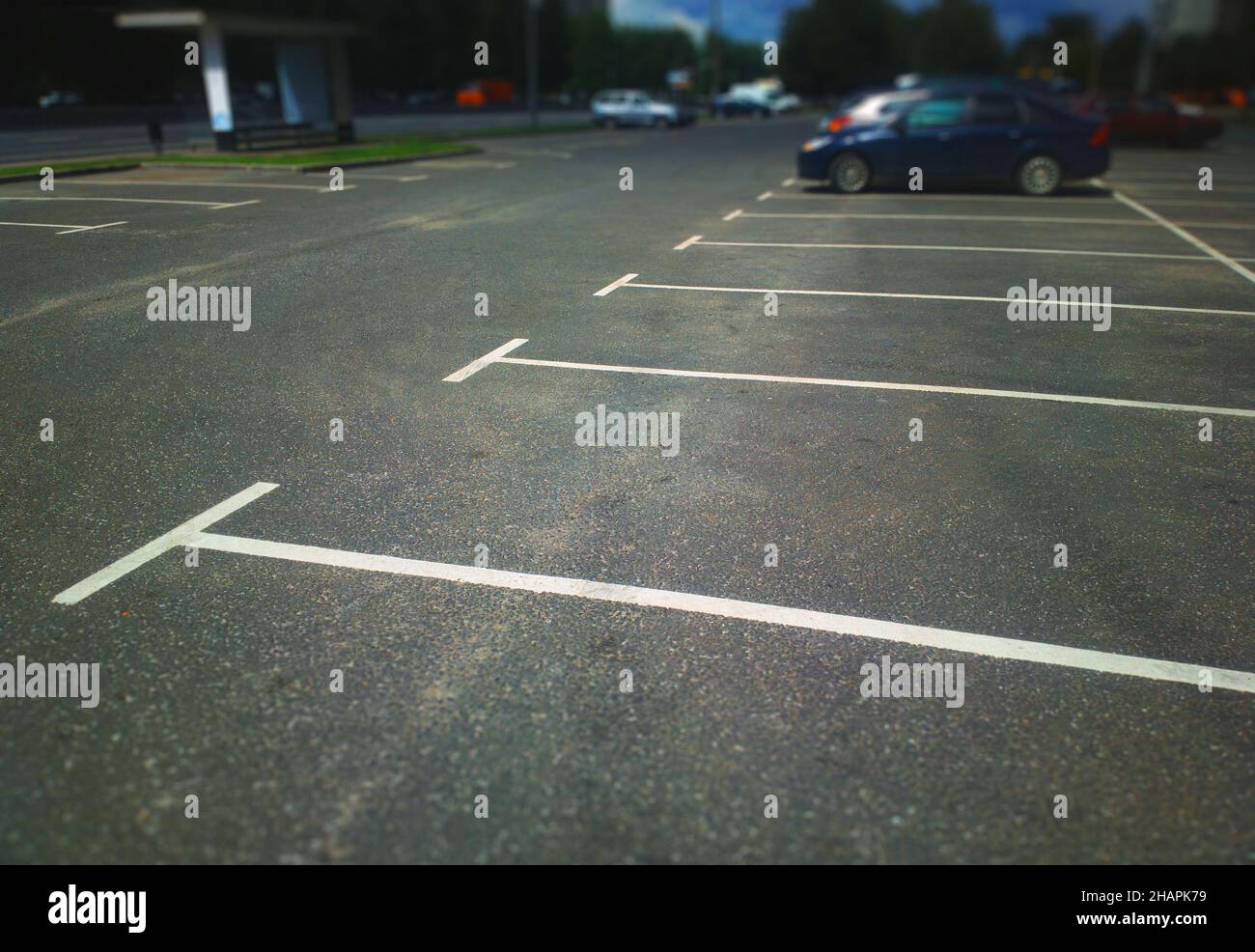 Almost empty car parking bokeh background Stock Photo - Alamy