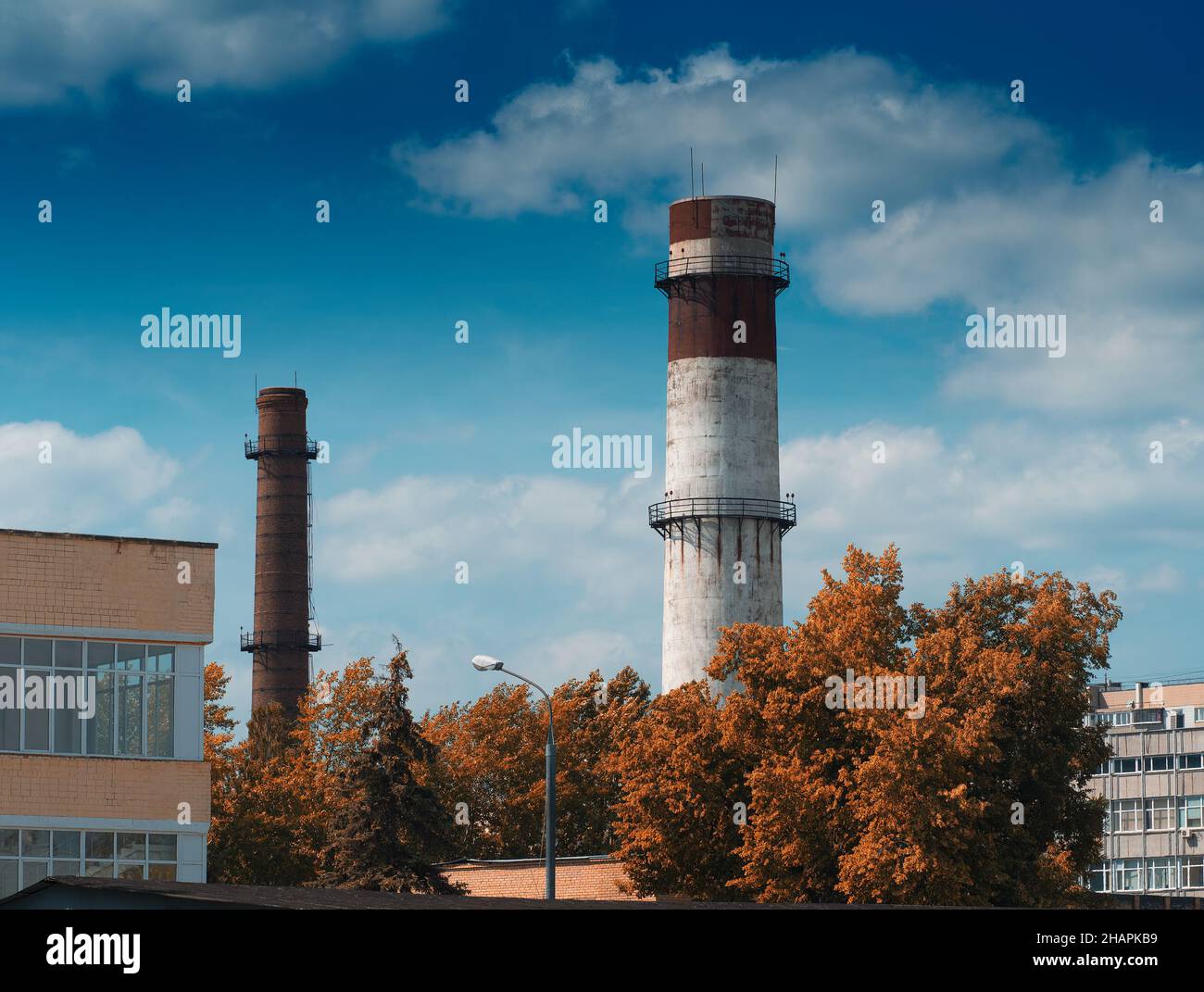Industrial chimneys at factory background Stock Photo - Alamy