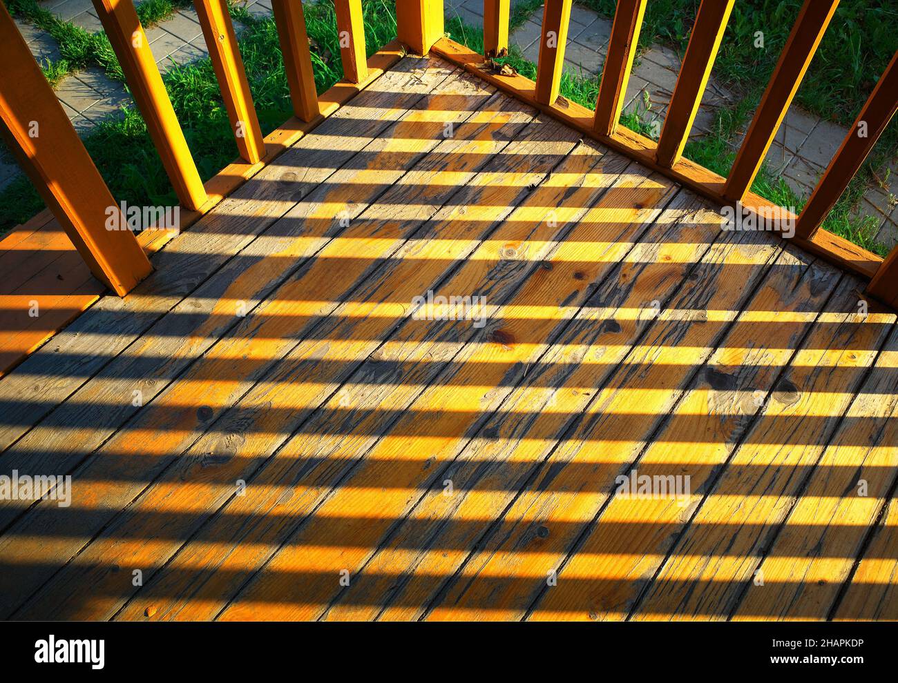 Wooden gallery with dramatic sunset shadows Stock Photo - Alamy