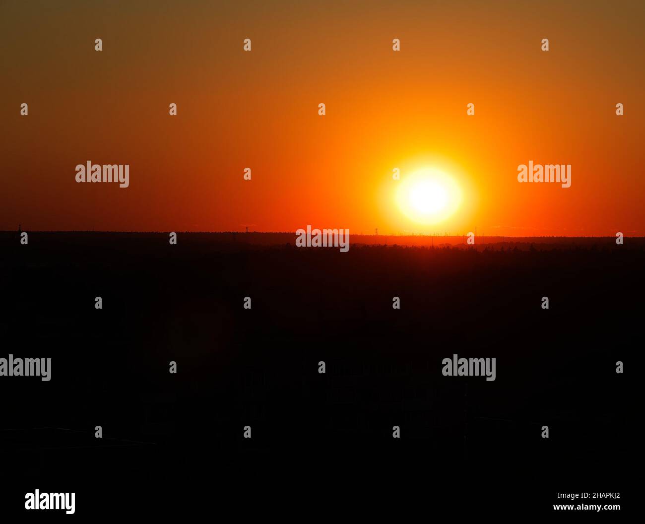 Burning sunset illuminating the horizon line background Stock Photo - Alamy