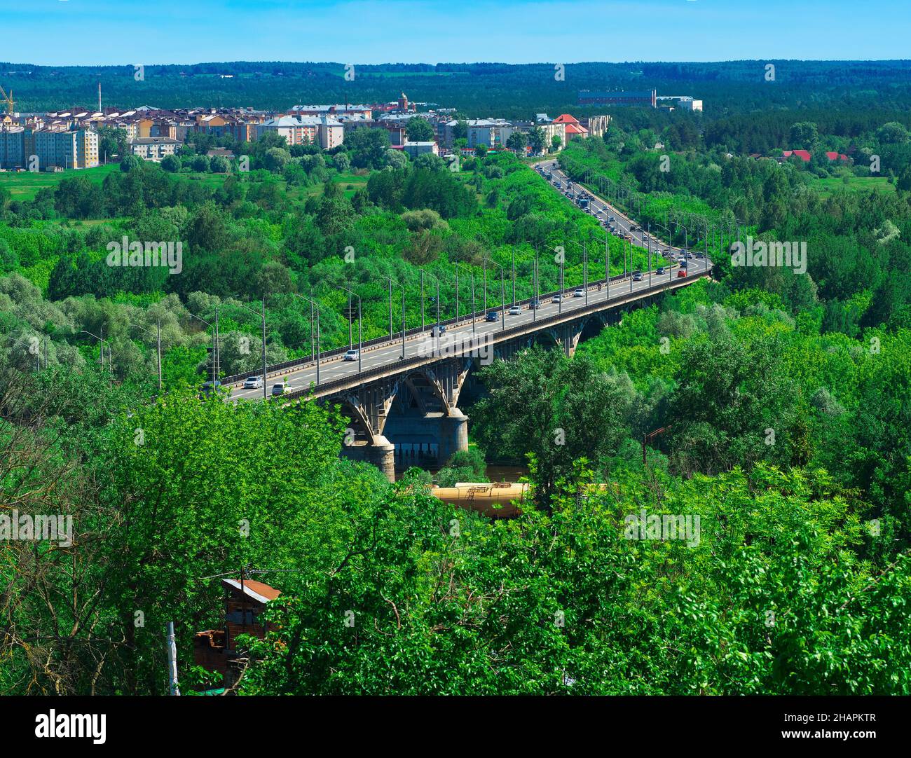 Diagonal highway bridge in green woods background Stock Photo - Alamy
