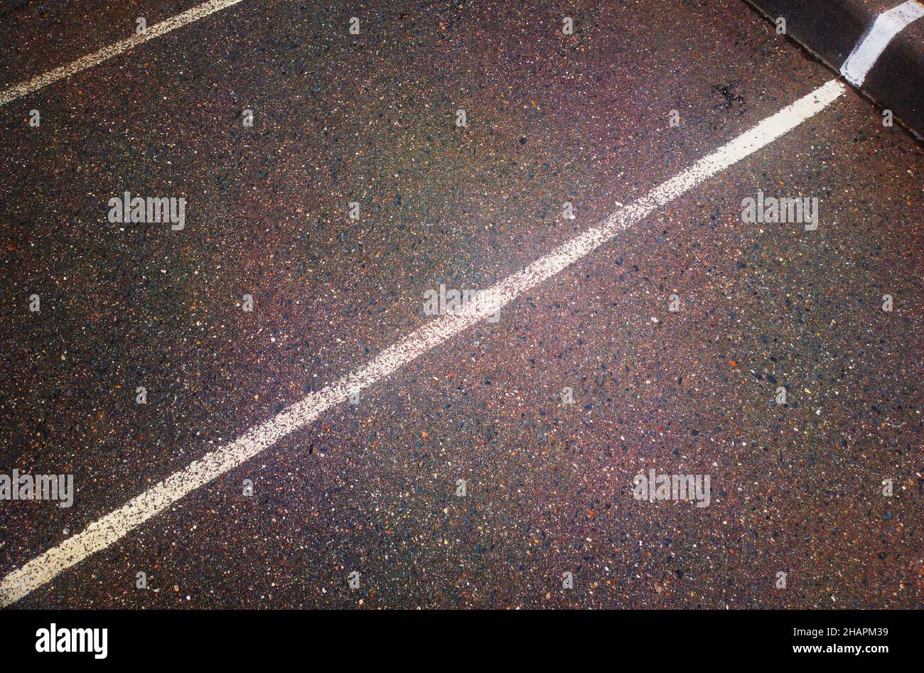 Diagonal white marking line on city road background Stock Photo - Alamy