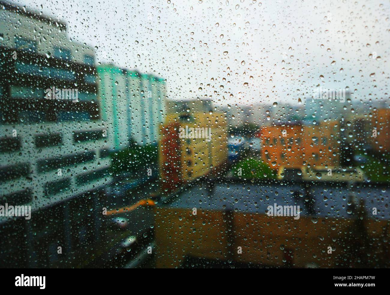 Industrial buldings through the wet windows background Stock Photo - Alamy