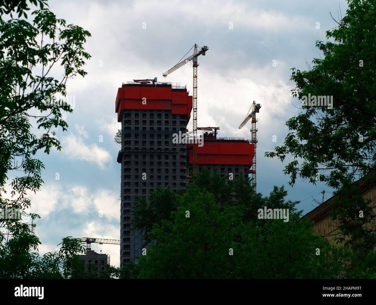 Construction cranes bulding house background Stock Photo - Alamy