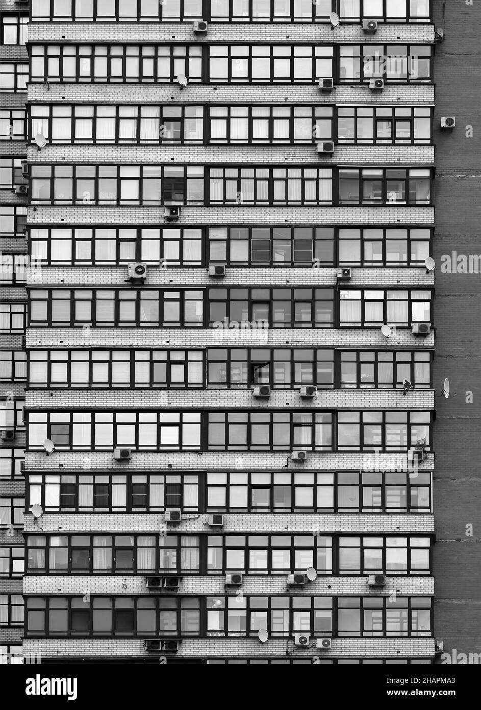 Symmetric windows of many-storied house bcakground Stock Photo - Alamy
