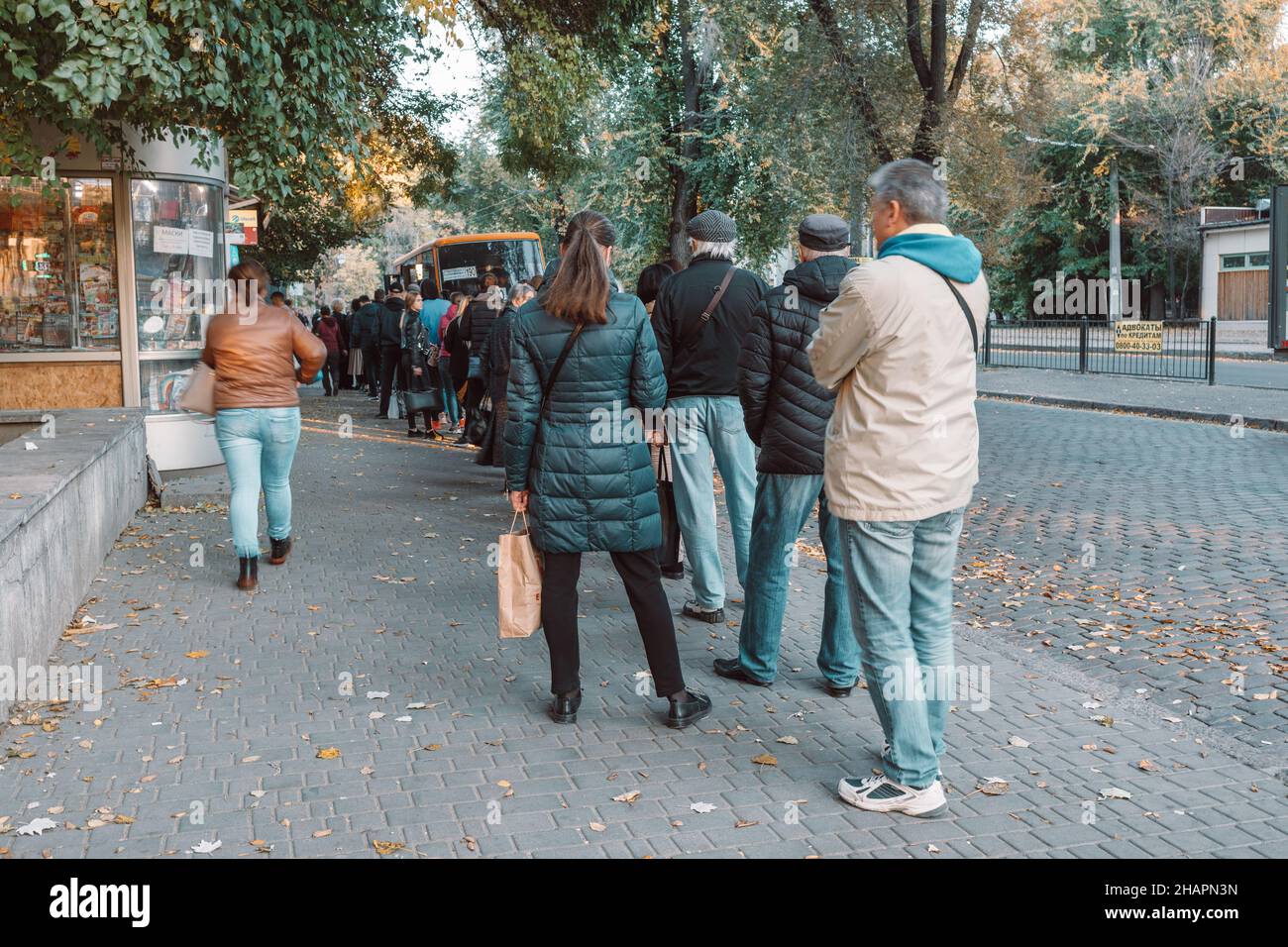 Unidentified queue of Unidentifiedpeople waiting at the bus stop Stock ...