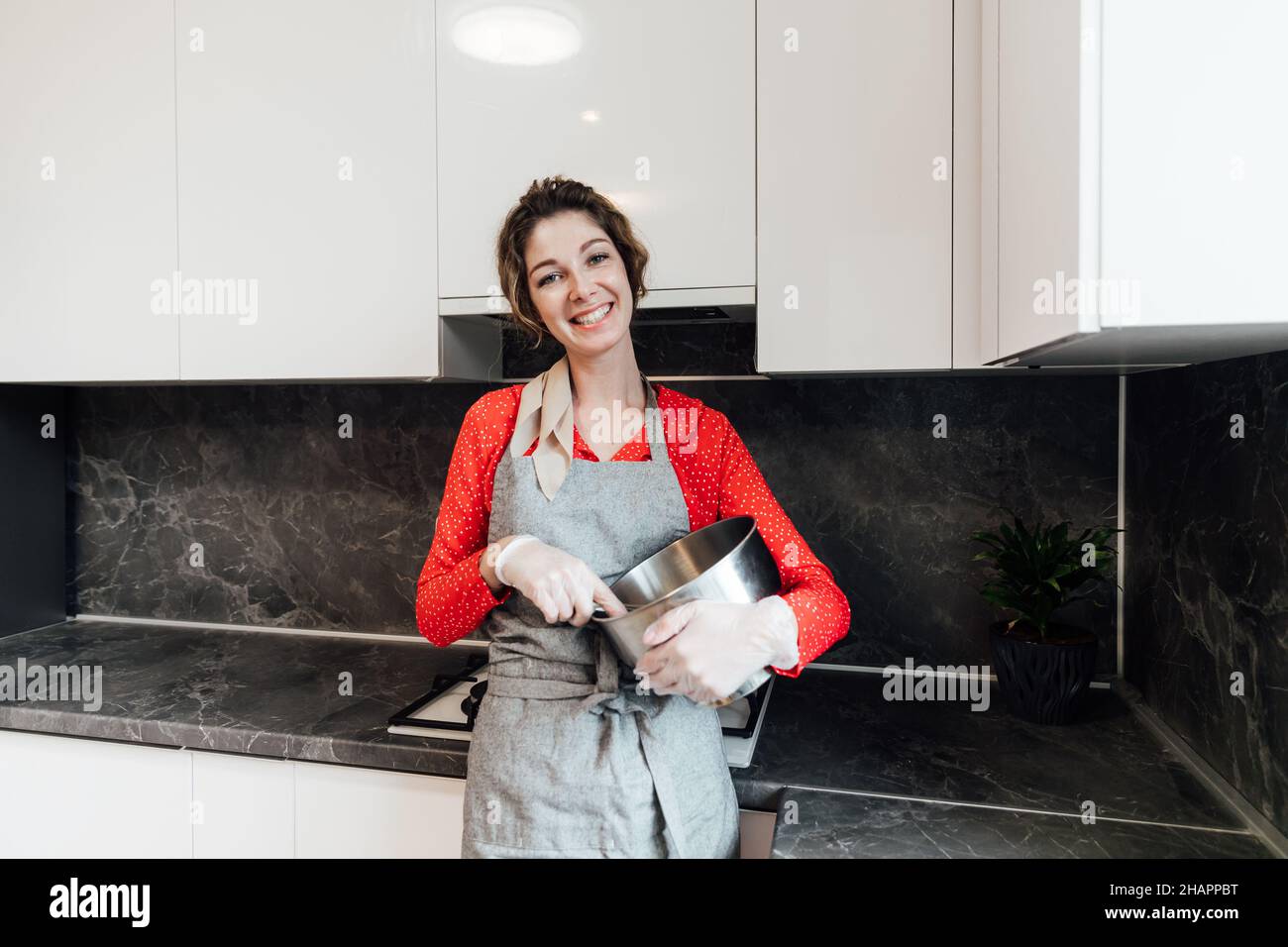 beautiful woman housewife cooks sweet dessert in the kitchen Stock ...