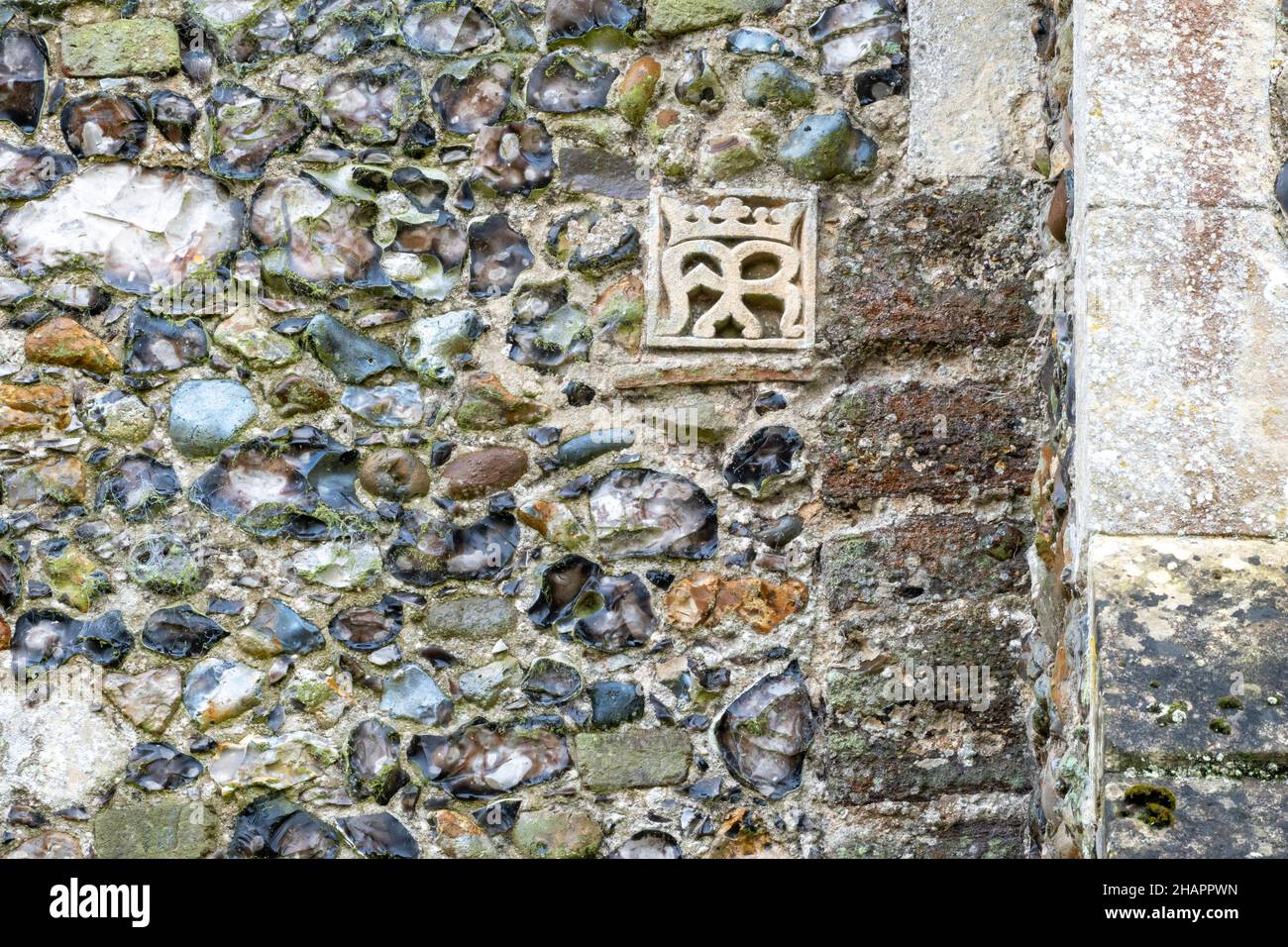Carved stone monogram with coronette above set in to a wall of the ...