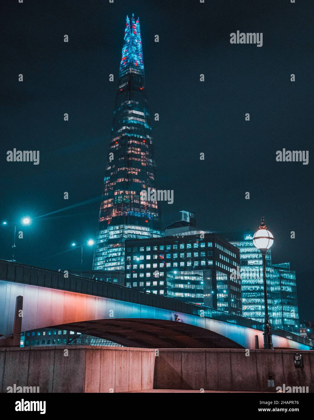 The shard illuminated behind London Bridge, a famous and popular part ...