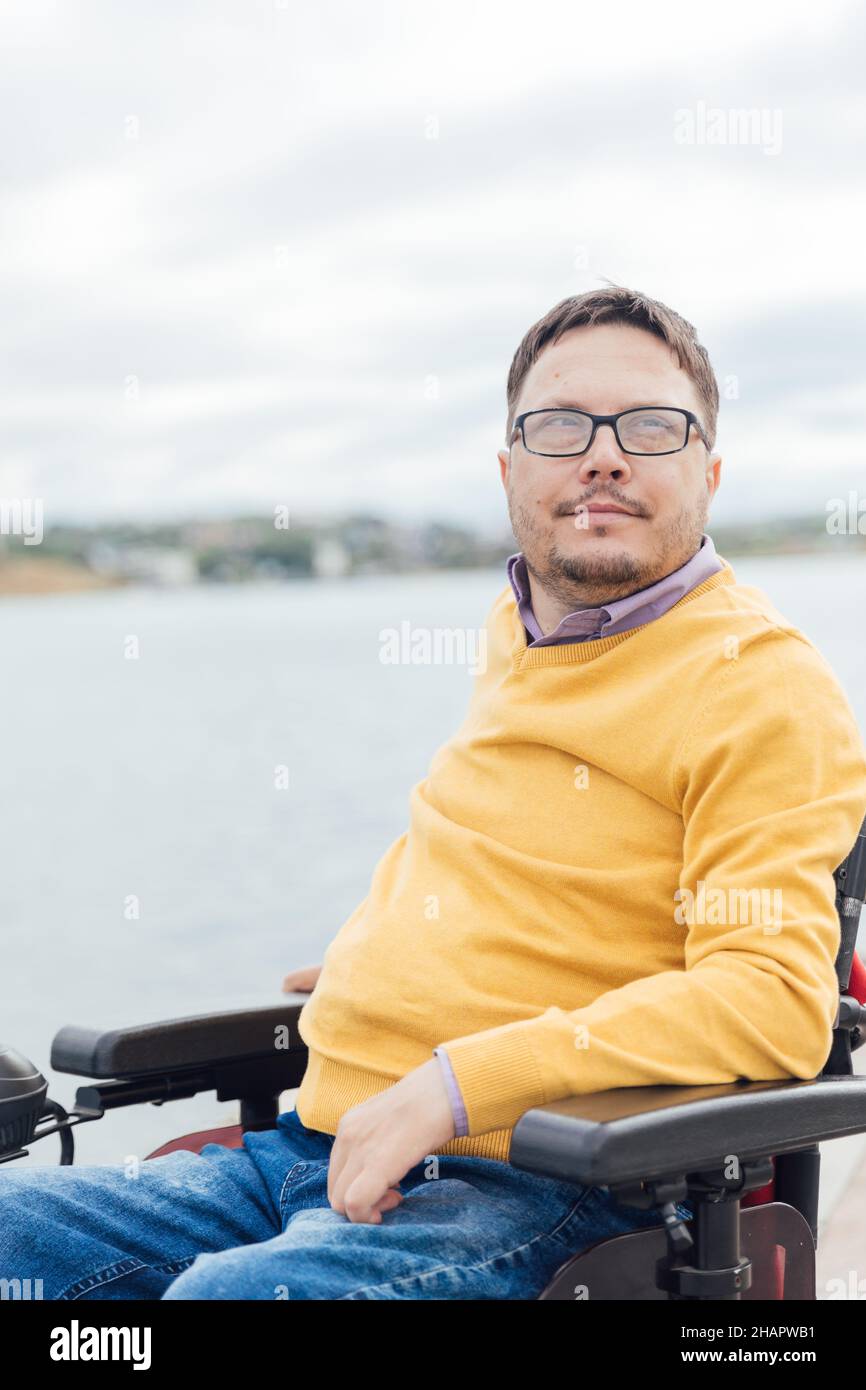 a man with disabilities in a wheelchair enjoys life Stock Photo - Alamy